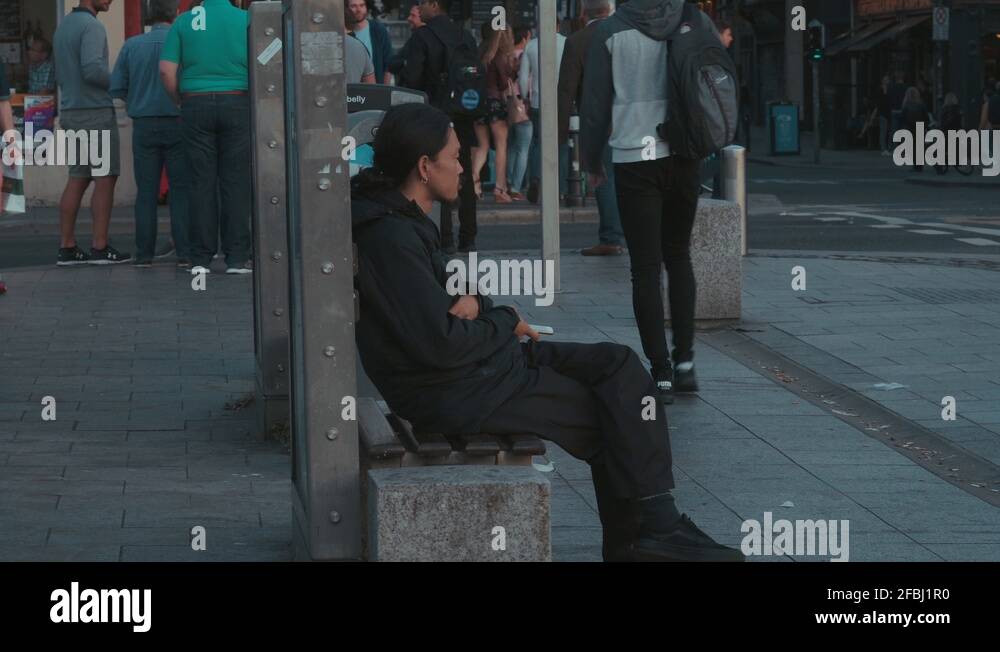 Thinking man sitting on a bench in the streets of Dublin, Ireland ...