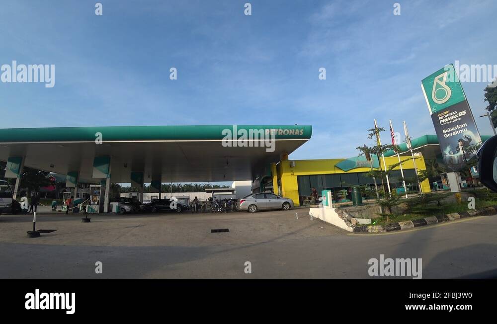Petronas petrol station during daytime in Malaysia. Customers come to ...