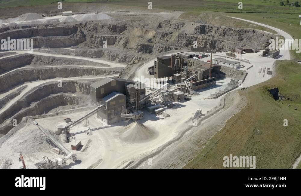 An aerial view of a working asphalt quarry building with the quarry cut ...
