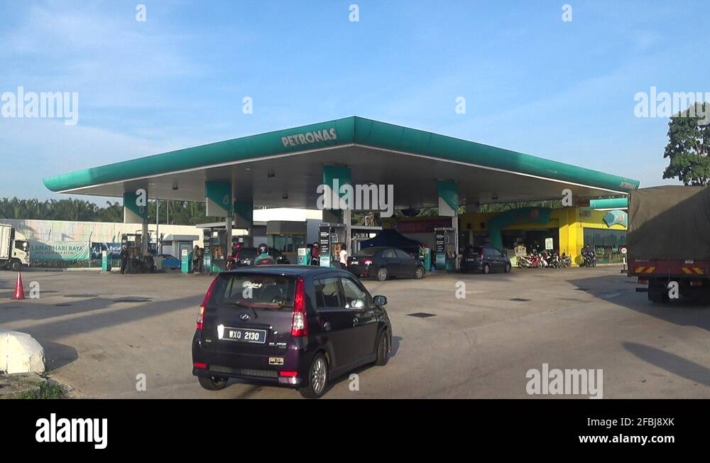 Petronas petrol station during daytime in Malaysia. Customers come to ...