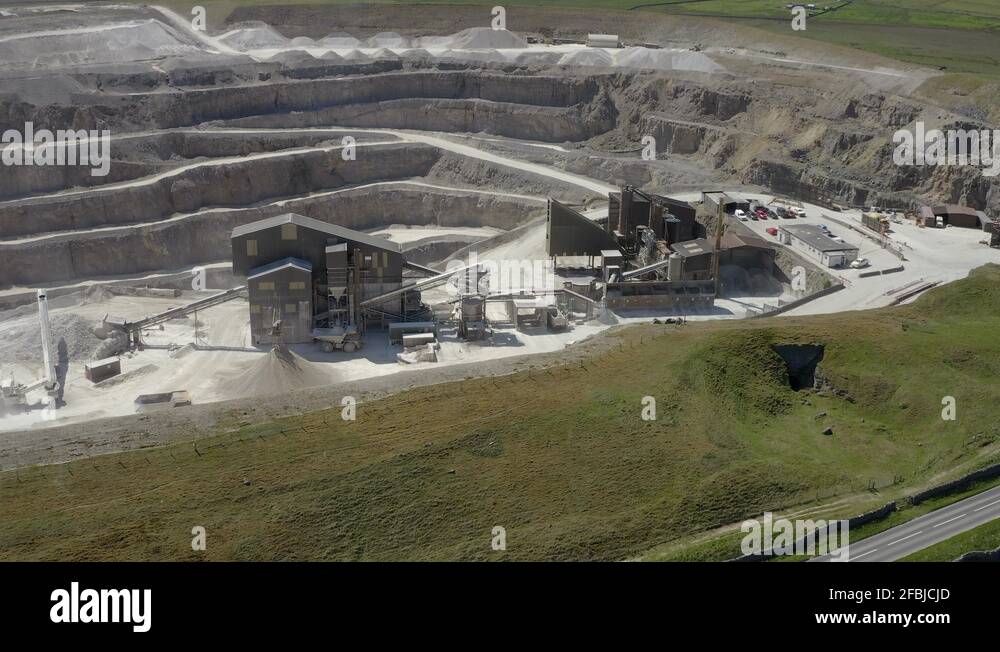 An aerial view of a working asphalt quarry building with the quarry cut ...