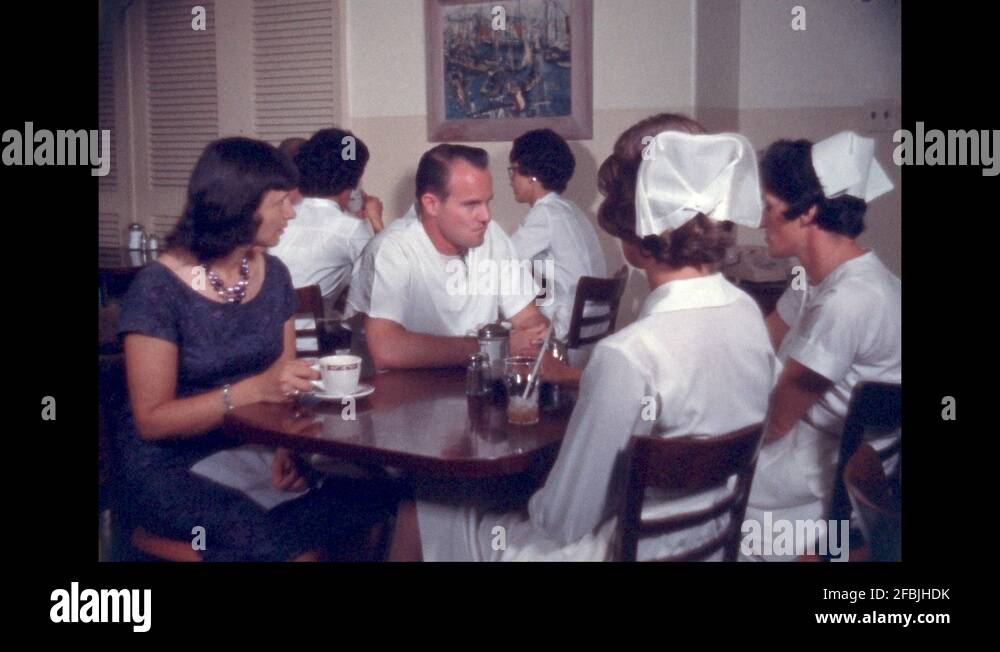 1960s: UNITED STATES: staff enjoy tea in staff room. Staff room break ...