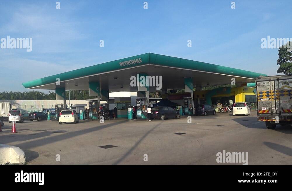 Petronas petrol station during daytime in Malaysia. Customers come to ...