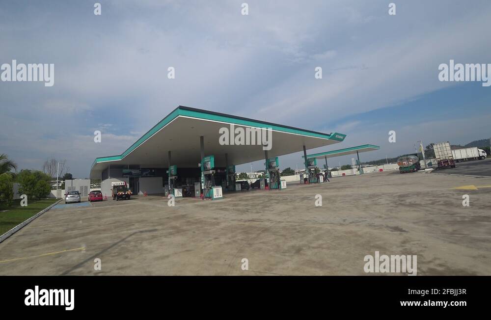 Petronas petrol station during daytime in Malaysia. Customers come to ...