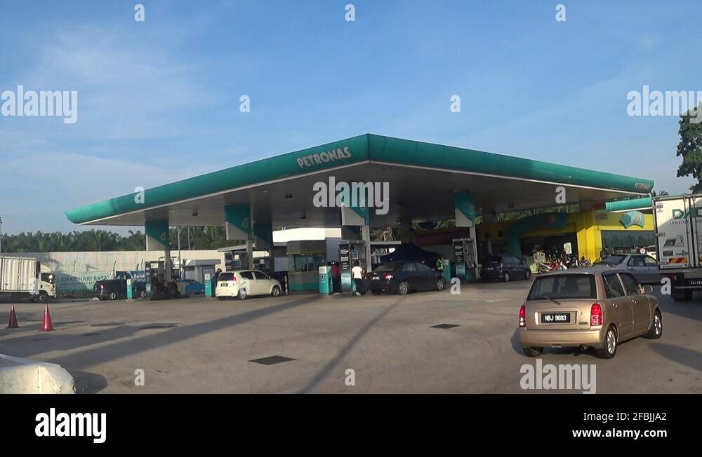 Petronas petrol station during daytime in Malaysia. Customers come to ...