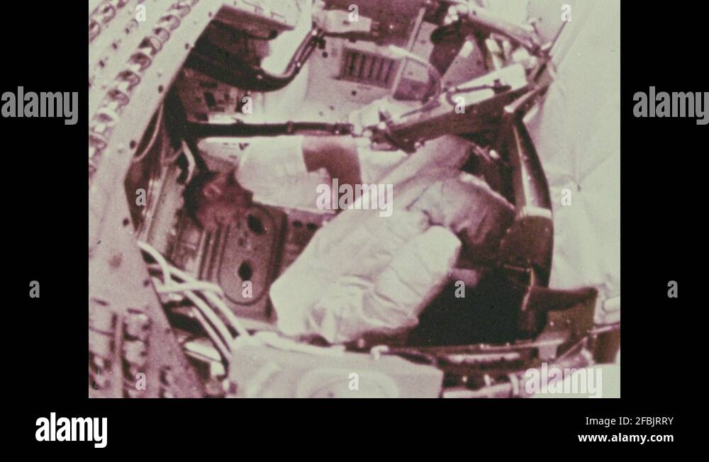 1960s: UNITED STATES: astronaut climbs into space suit in command ...