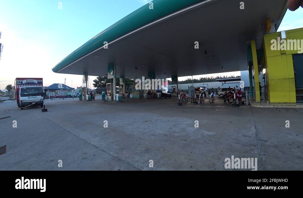 Petronas petrol station during daytime in Malaysia. Customers come to ...