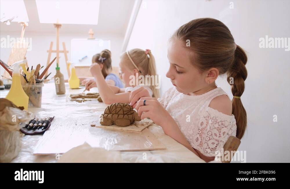 Lesson in art workshop in elementary school. Kids are modeling toys ...