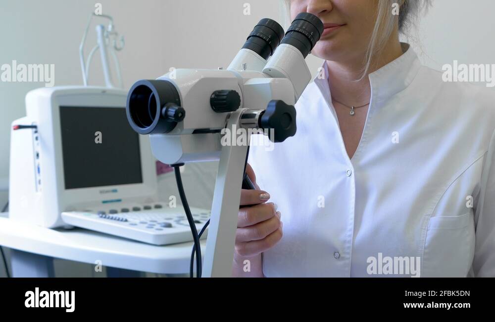 A professional gynecologist woman examines a patient with a colposcope ...