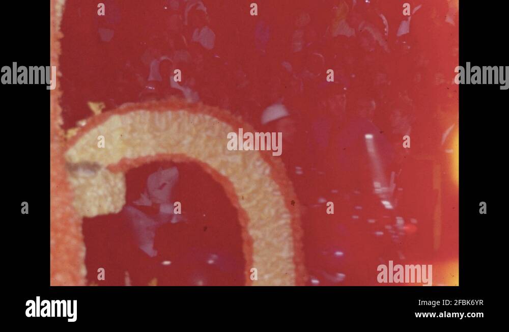 1960s: Woman waves from parade float. Women seated on parade float wave ...