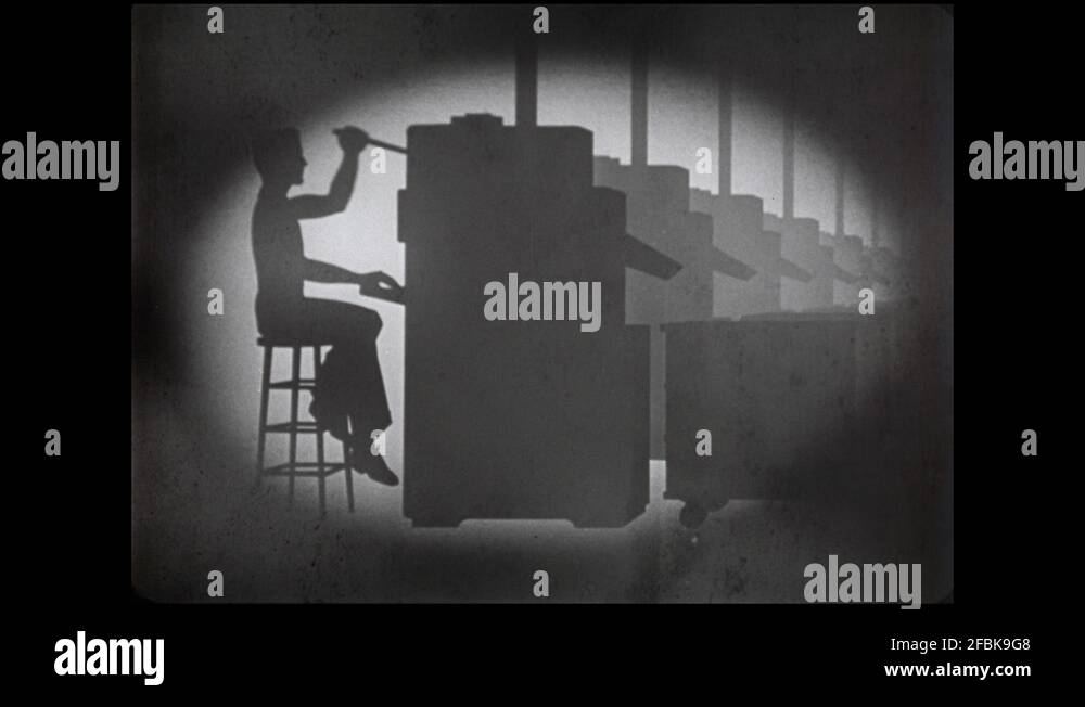 1960s: Shadow of man working on industrial machine. Text appears on ...