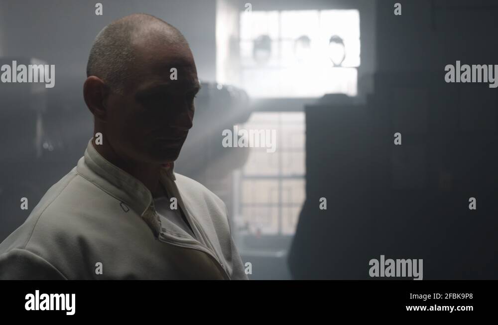 An older man fencer putting on his fencing mask in a locker room Stock ...