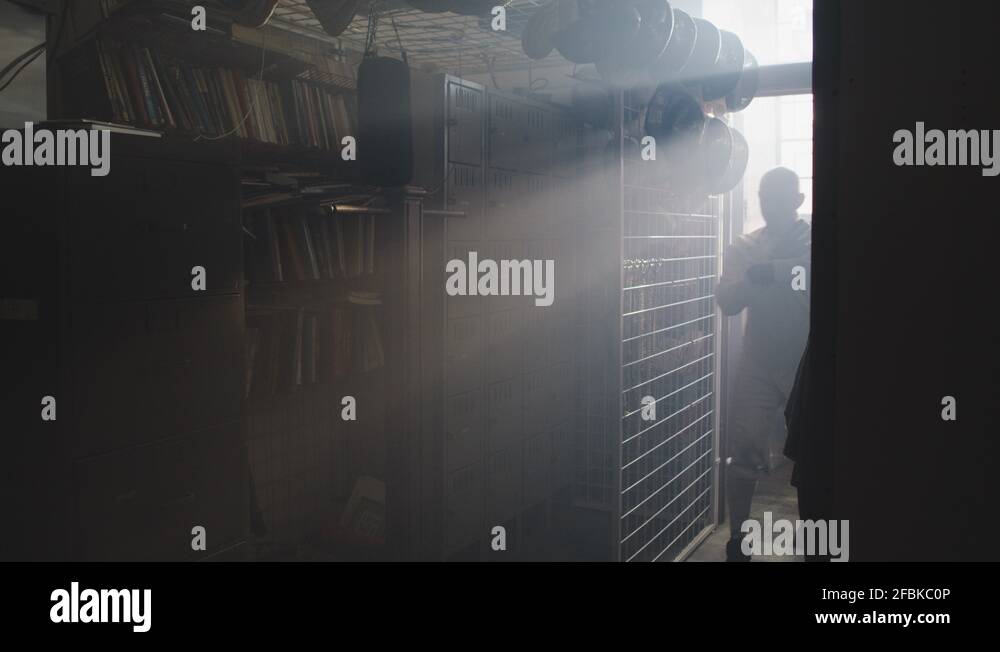 Man checks his foil and puts on his fencing mask in a locker room Stock ...