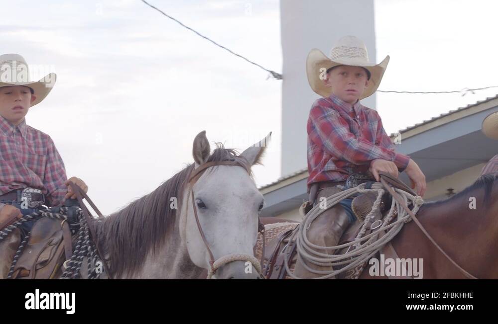 Children on horseback on old fashioned Texas family ranch, close shot ...