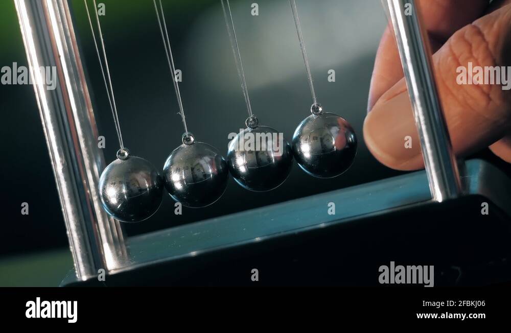 Newton's cradle in motion, five-ball system in one-ball swing. Inclined ...