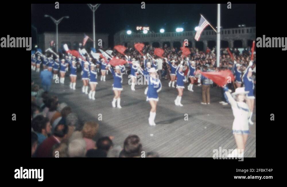 1970s: Women of color guard wave flags and march in parade. Pageant ...