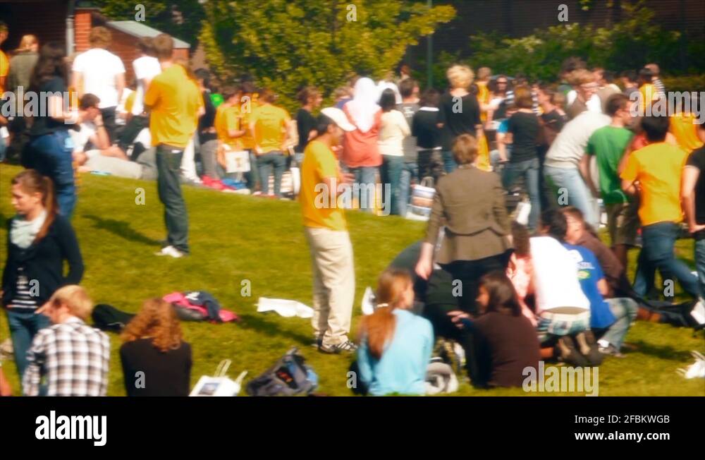 College students gathered in a circle introducing themselves during an ...