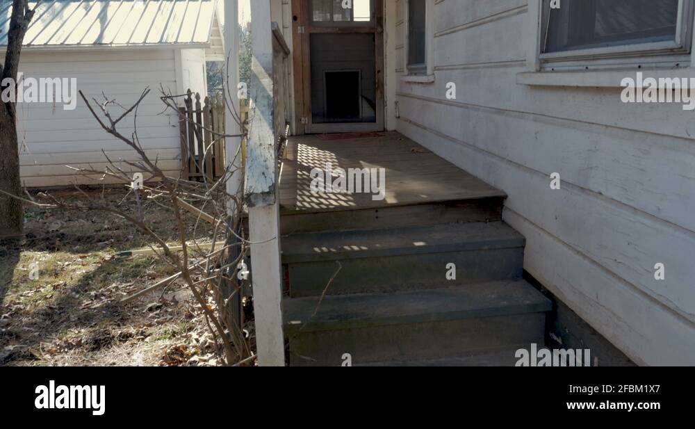 Tilt up of a back door entrance of a home and window with a misaligned ...