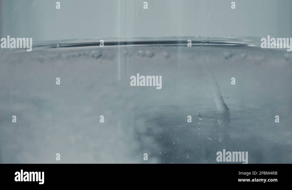 a glass with water and a effervescent headache tablet dissolve Stock ...
