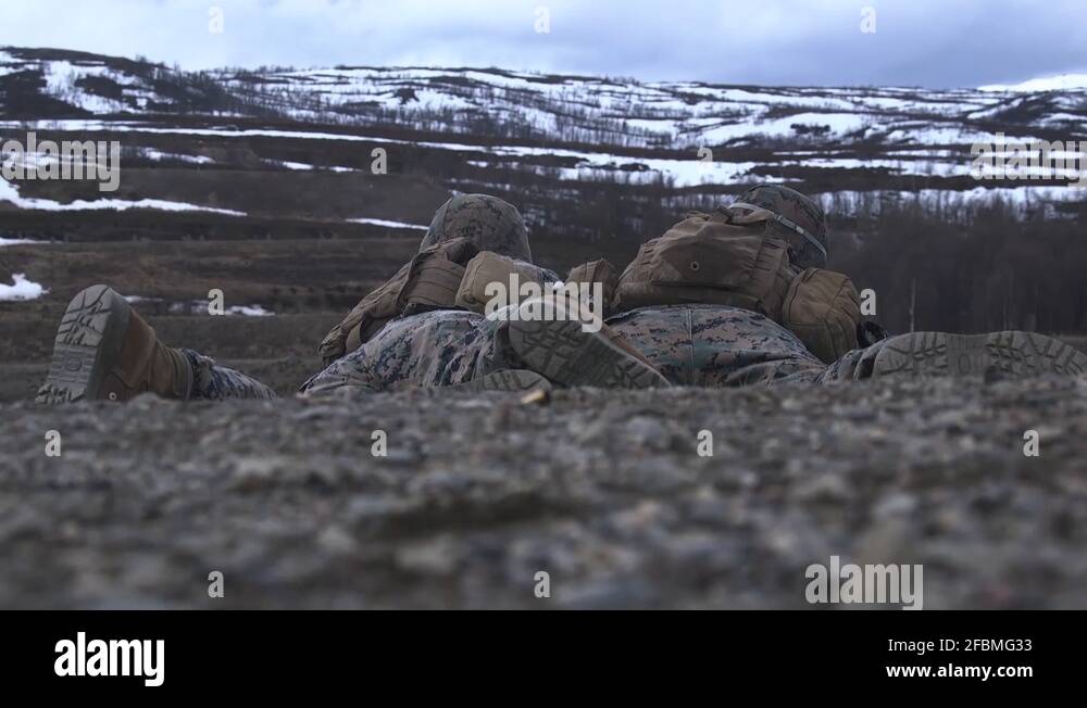 Soldier firing machine gun during live fire training at Bardufoss ...