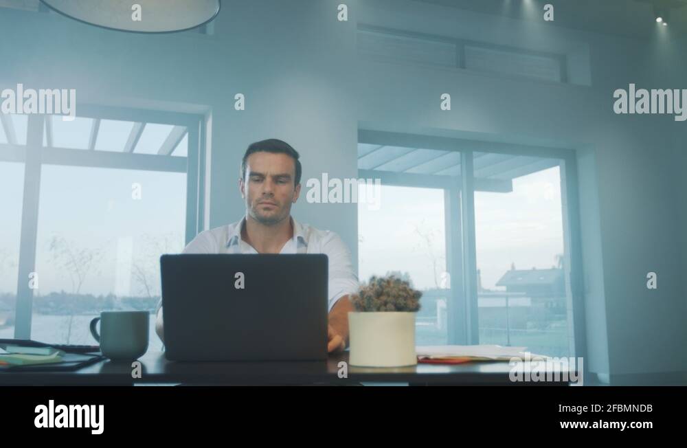 Business man trying to relax in luxury house. Tired man relaxing at ...