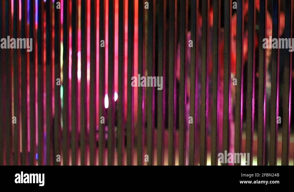 girl and boyfriend dancing in a nightclub behind bars. Dancing couple ...