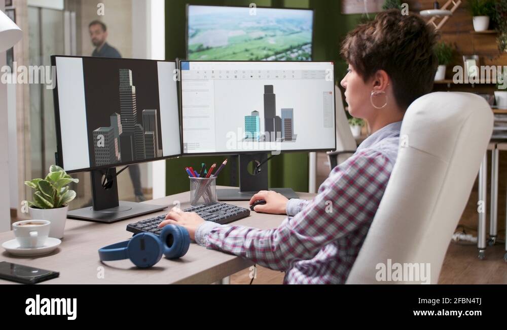 Young female architect uses a CAD or 3D software to design a new ...