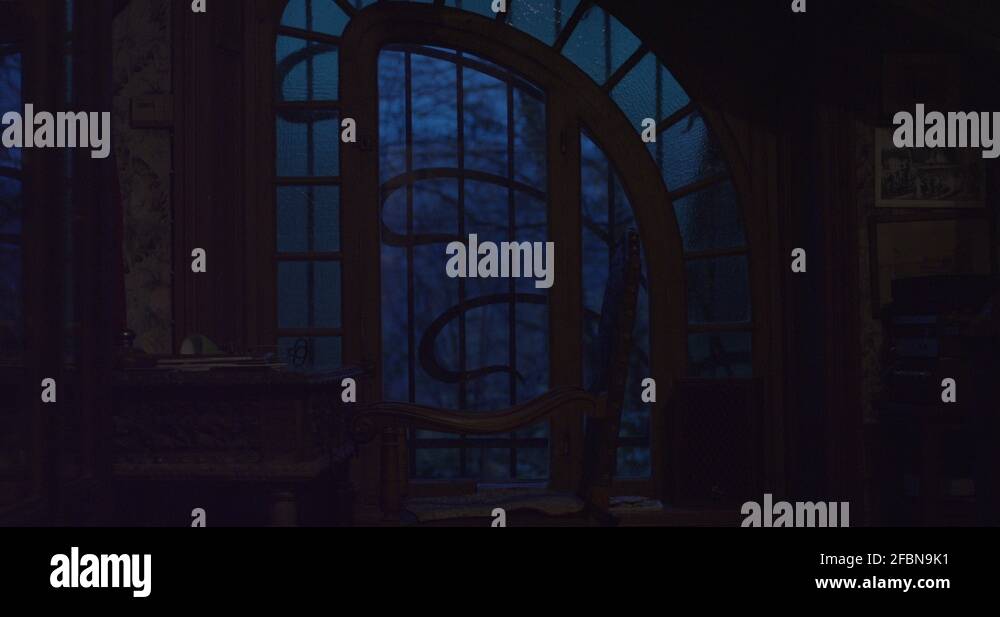 Old creepy window of a scary haunted house overlooking a haunted forest ...