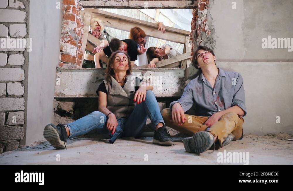 Doomsday, apocalypse. Two survived people sitting on the floor and ...