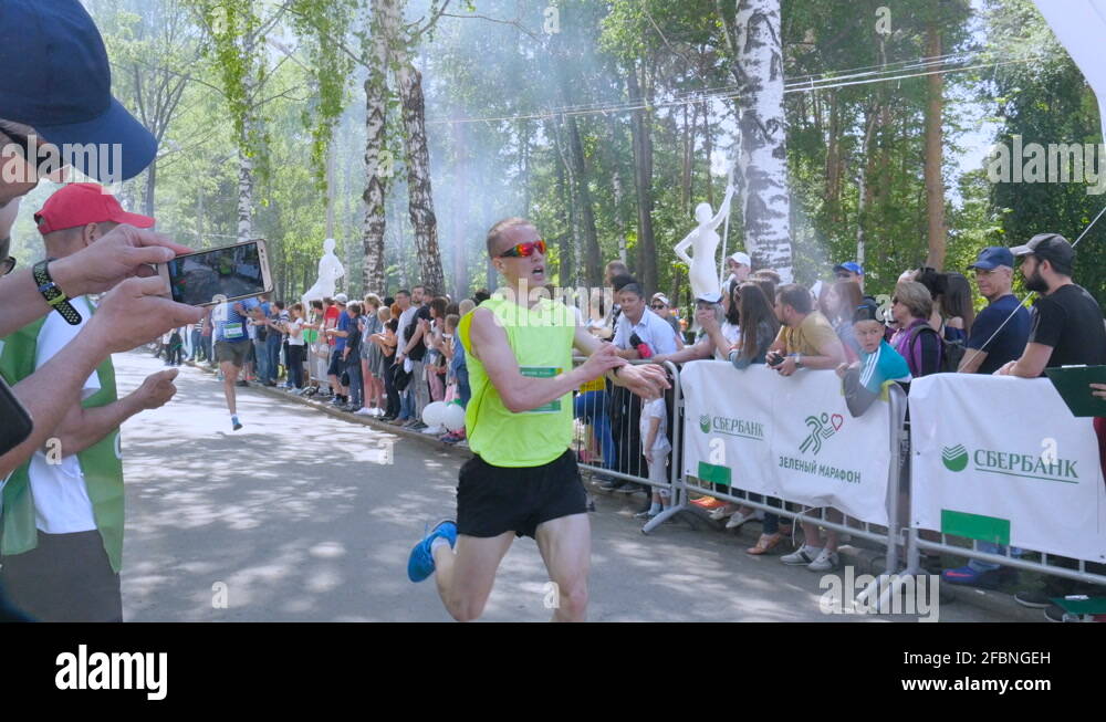 Man completes the marathon and runs through the finish line Stock Video ...