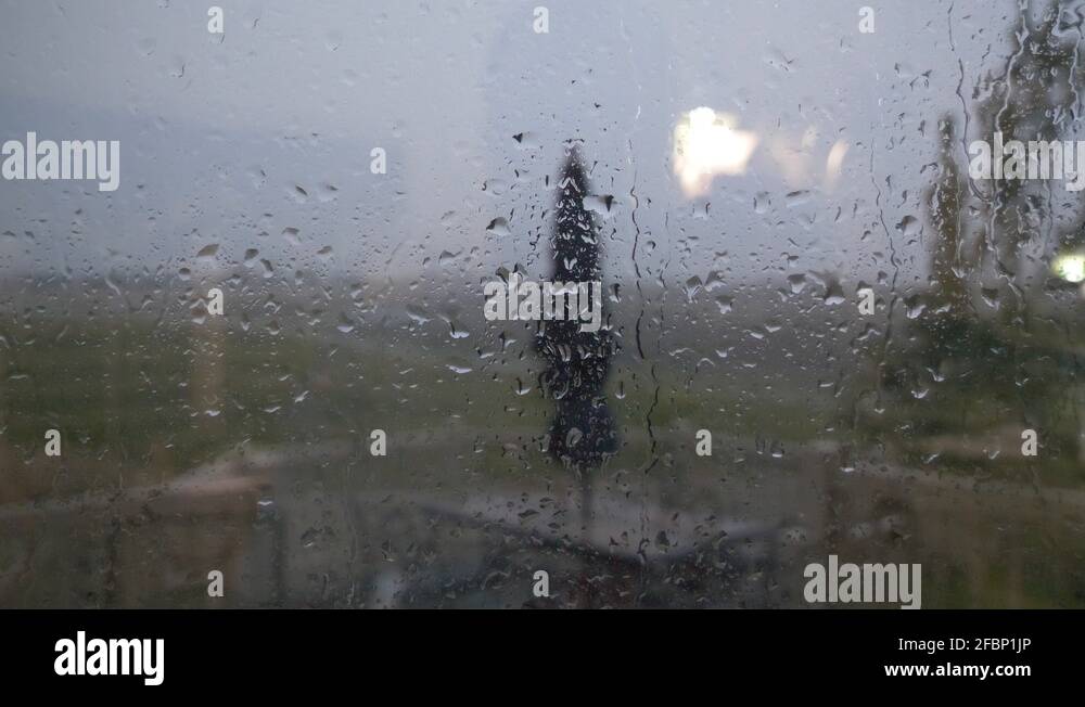 Looking through a window at the backyard during a violent thunderstorm ...