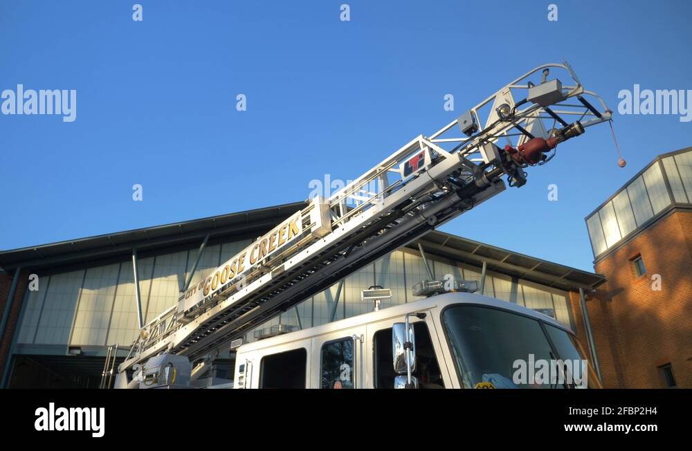 Fire engine sits shiny outside of a fire station in the early morning ...
