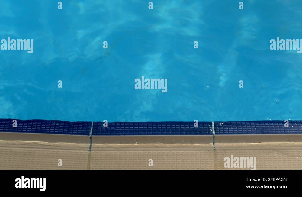 Water splash in pool edge. Water park chill holidays during hot summer ...