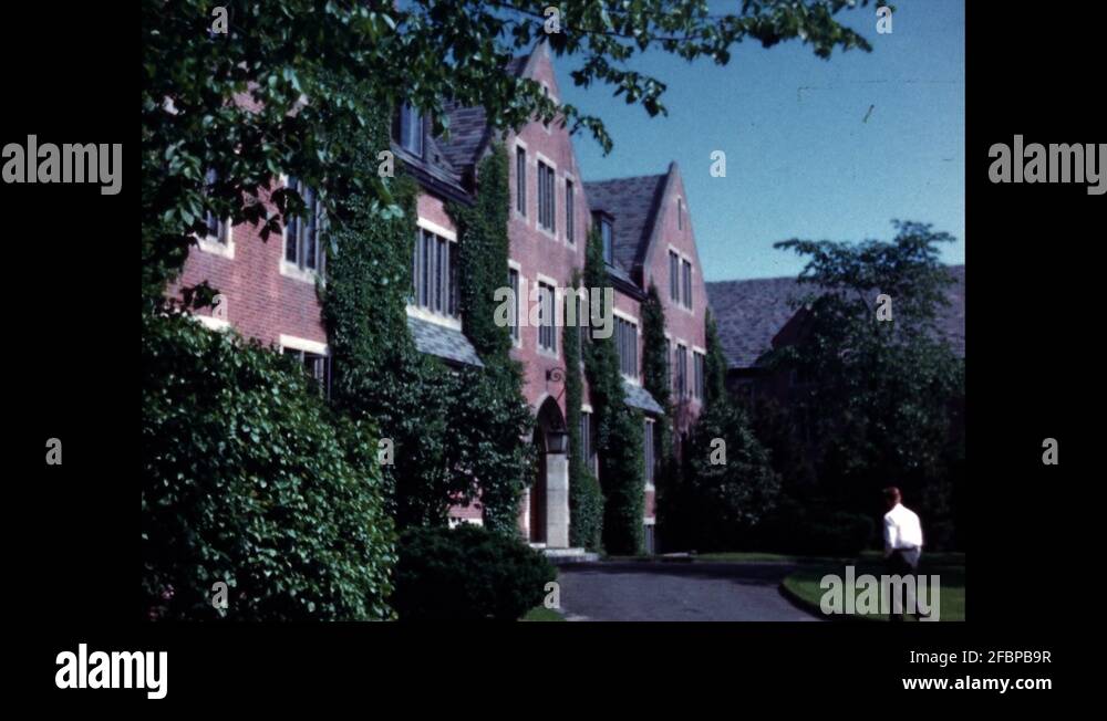 1950s: Student walks toward ivy-covered school building on campus Stock ...