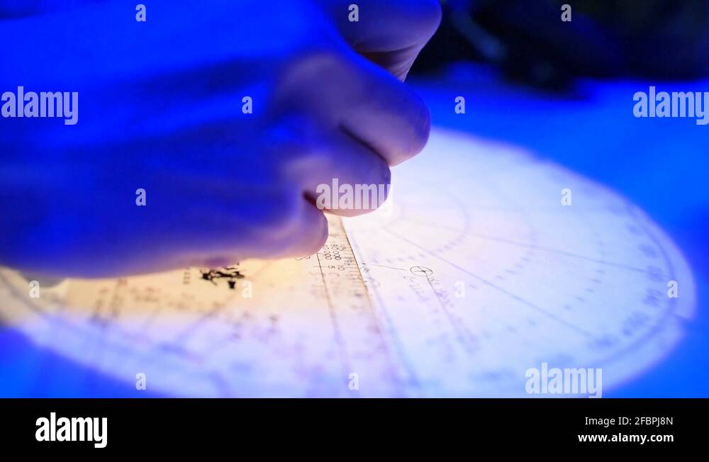 Sailor working on navigation chart in control room aboard USS Mount ...