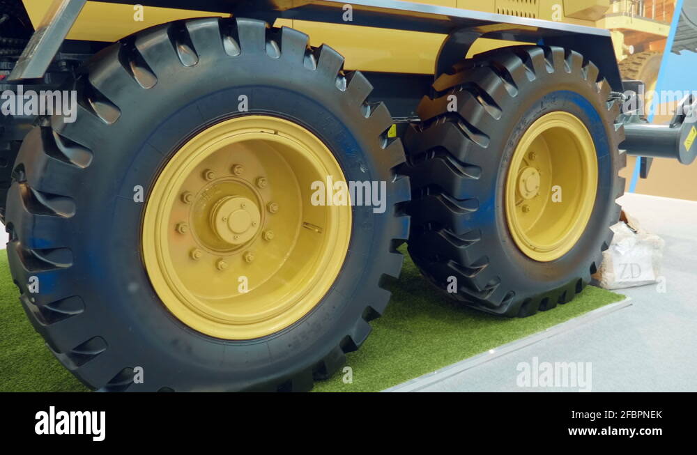 Big new wheels with yellow rims on a construction tractor Stock Video ...