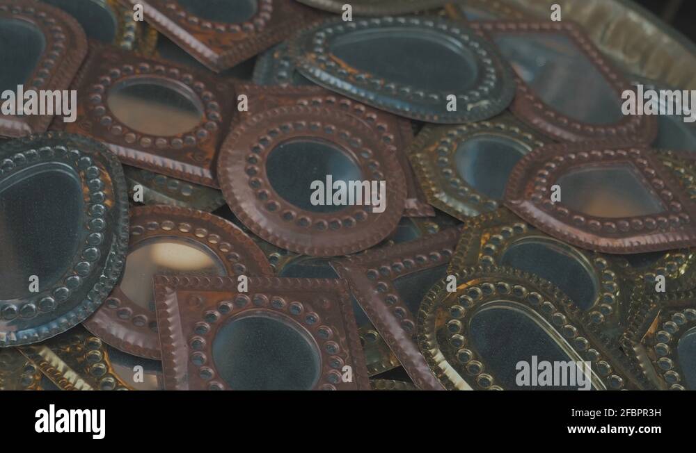Close up panning above a market stall display of gold silver and rose ...