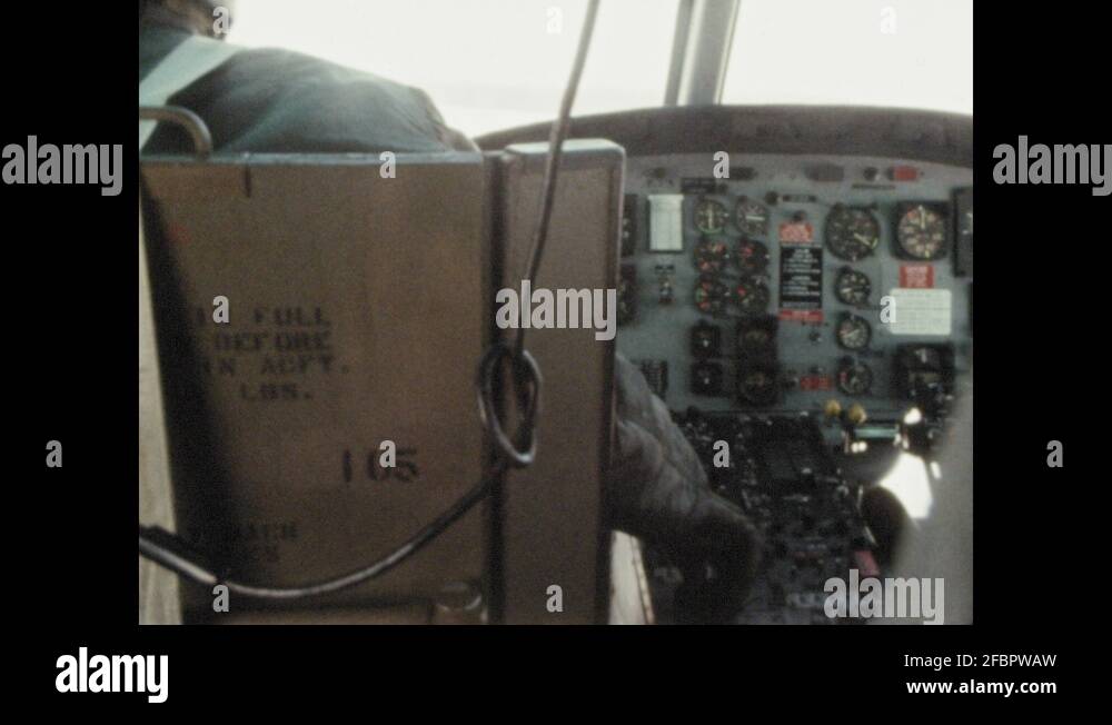 1970s: UNITED STATES: pilot flies helicopter. Rear view of helicopter ...