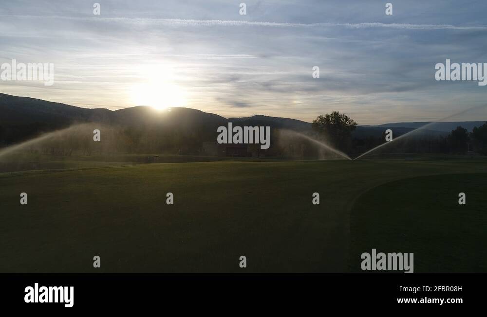 Video of watering the lawn of a golf course. Shooting done at ground ...