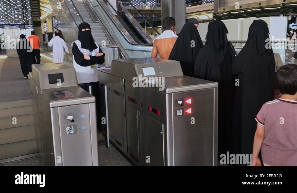 Muslim women pass through an autamatic gate at Madinah station, Saudi ...