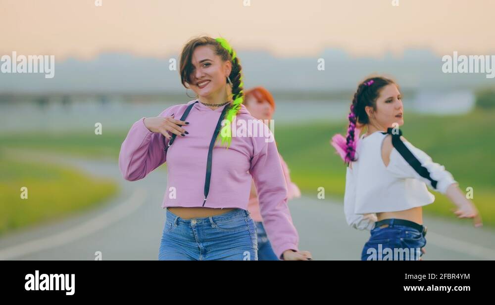 Pretty girls go on the road and dance. Back view Stock Video Footage ...
