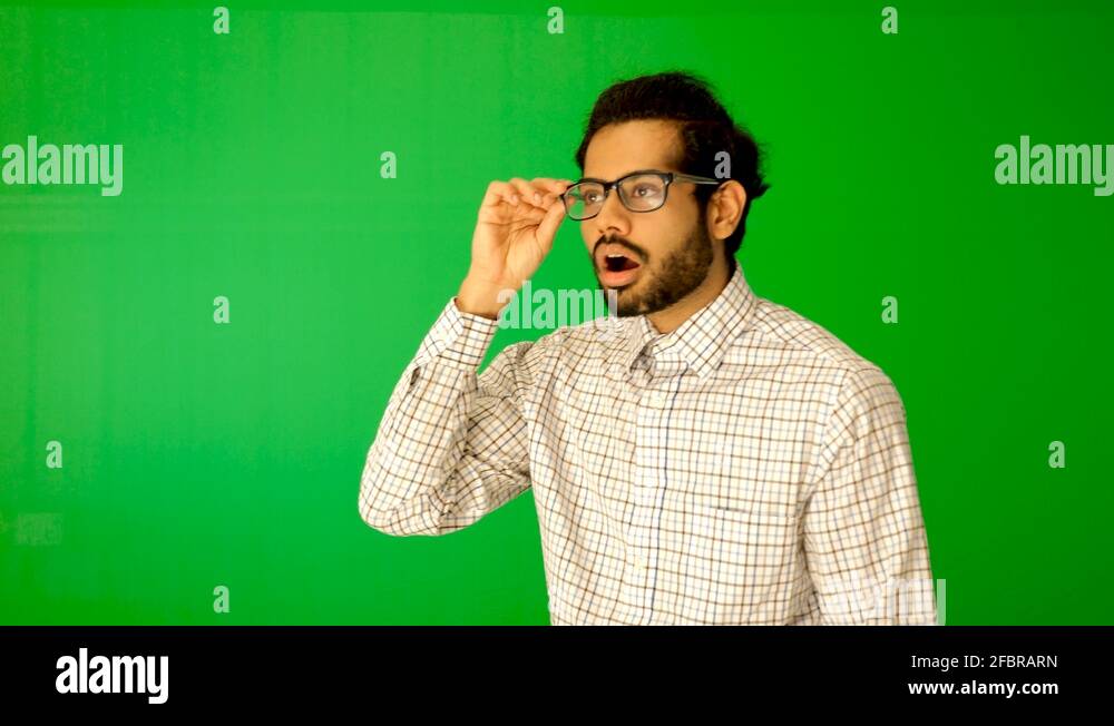 Indian guy express emotion with green background green screen Stock ...