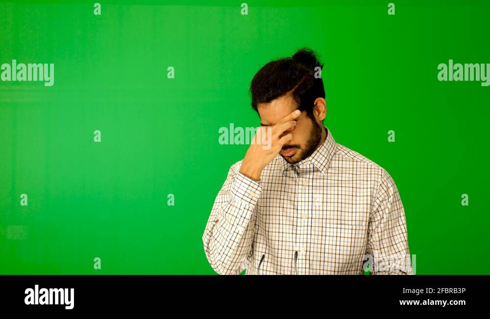 Indian guy express emotion with green background green screen Stock ...