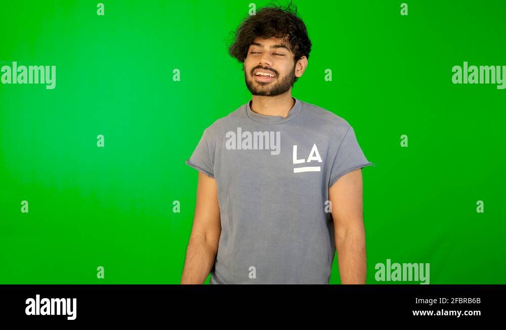 guy talking in front of camera with green screen and green background ...