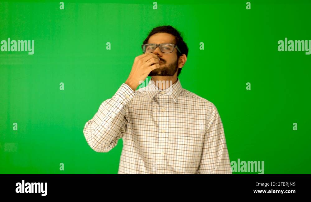 Indian guy express emotion with green background green screen Stock ...
