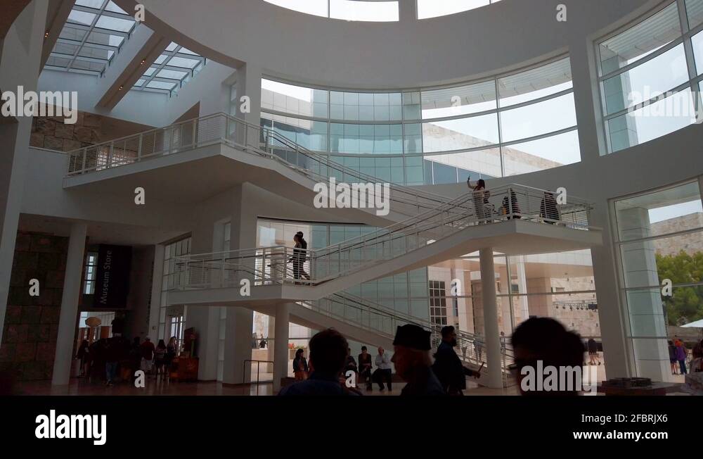 A busy lobby of a modern looking two story entrance building with an ...