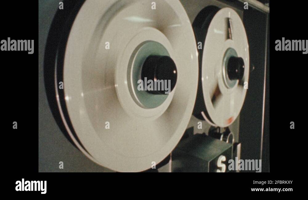 1960s: Computer reels spin. Liquid colors float in water. Woman types ...