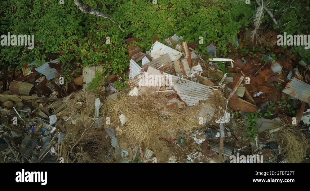 Garbage landfill or dump in jungle of Tonga, Aerial Spinning Top Shot ...
