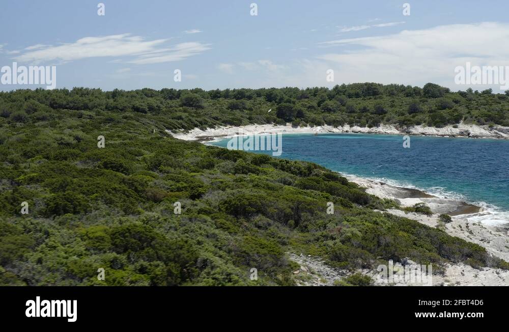 Beaches of Proizd Island, pan as birds glide in warm ocean air in ...
