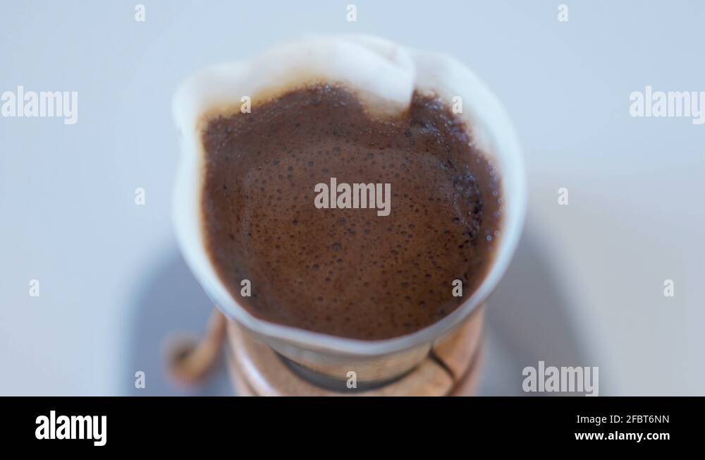 Steaming coffee in the top of a drip coffee set up right after the ...